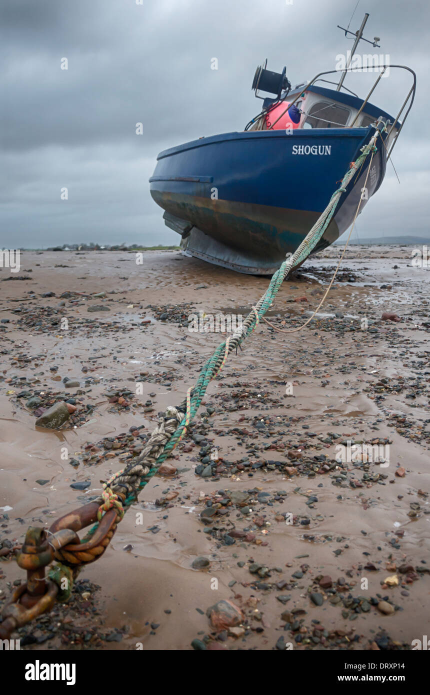 A boat stranded on the sands at low tide at Ravenglass in the Lake ...