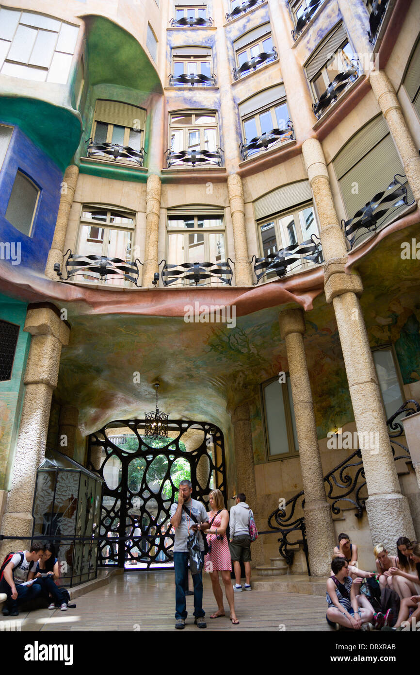 Spain, Catalonia, Barcelona, Tourist in central courtyard of Casa Mila ...