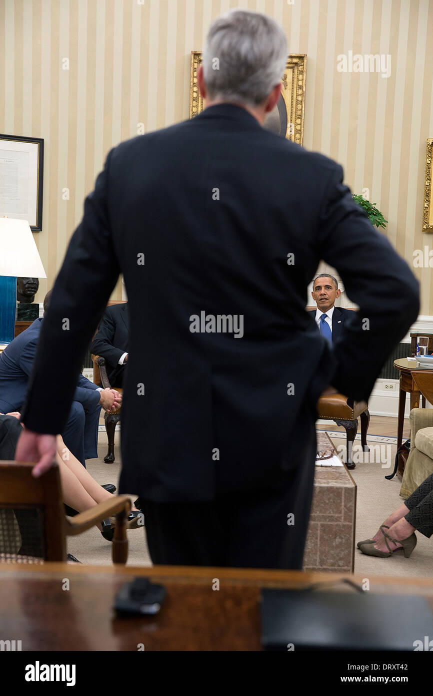 US President Barack Obama is framed through the arm of Chief of Staff ...