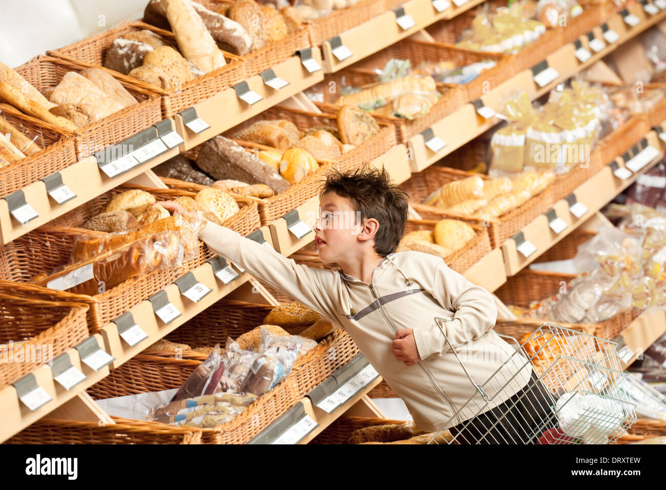 Grocery store shopping - Boy buying bread Stock Photo - Alamy