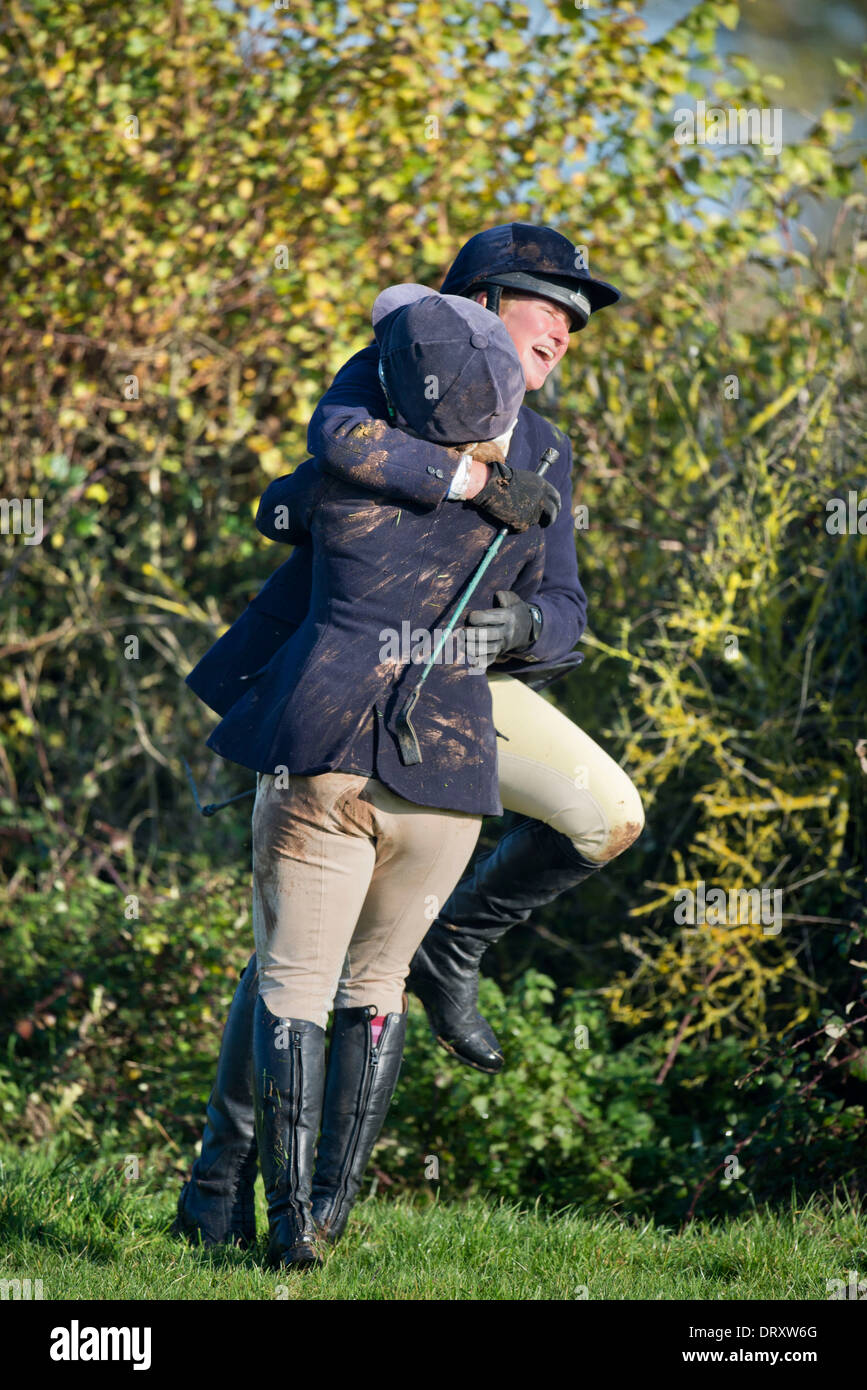 Horse riders embrace after falling from their mounts while following ...