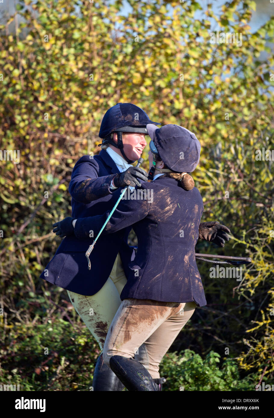 Horse riders embrace after falling from their mounts while following ...