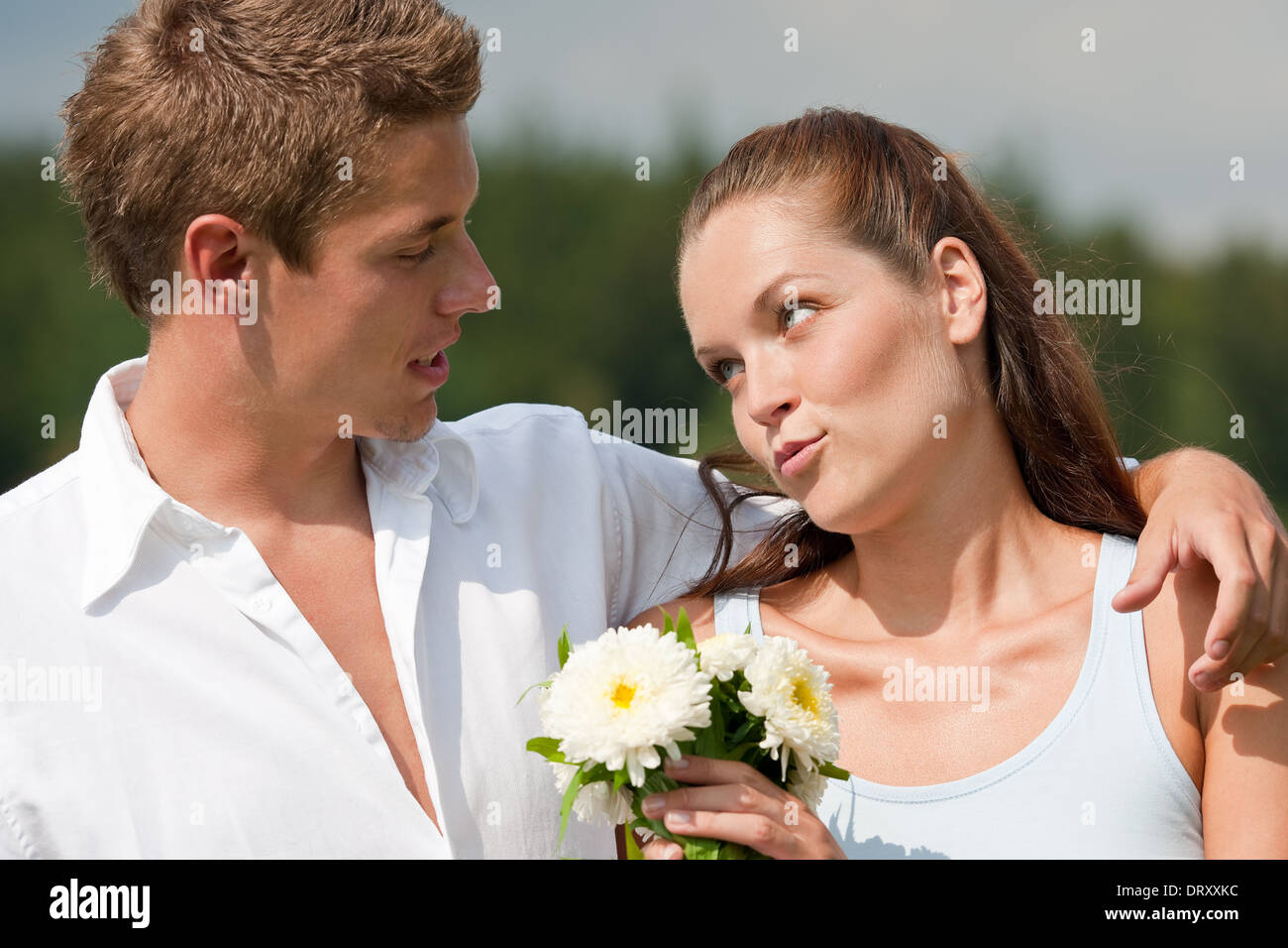 Romantic couple with flower in spring Stock Photo - Alamy