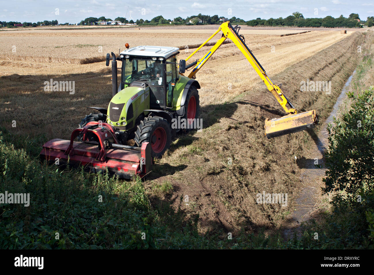 Class tractor clearing Fen ditch Stock Photo - Alamy