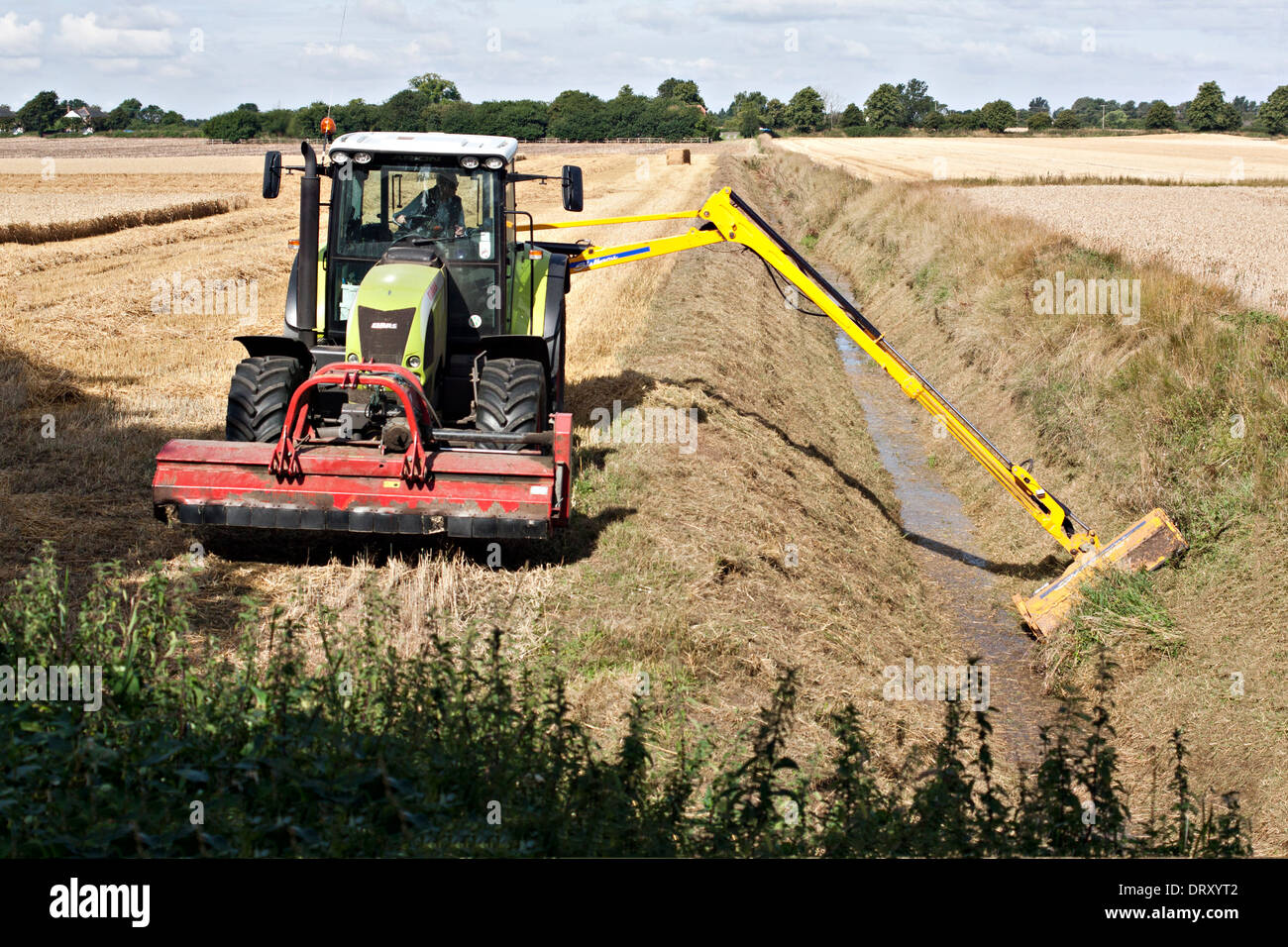 Class tractor clearing Fen ditch Stock Photo - Alamy