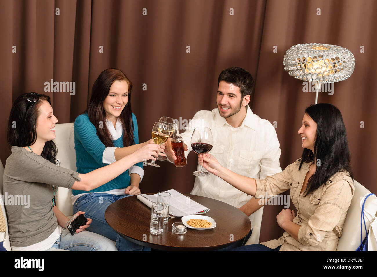 Happy friends enjoy drink at bar Stock Photo - Alamy
