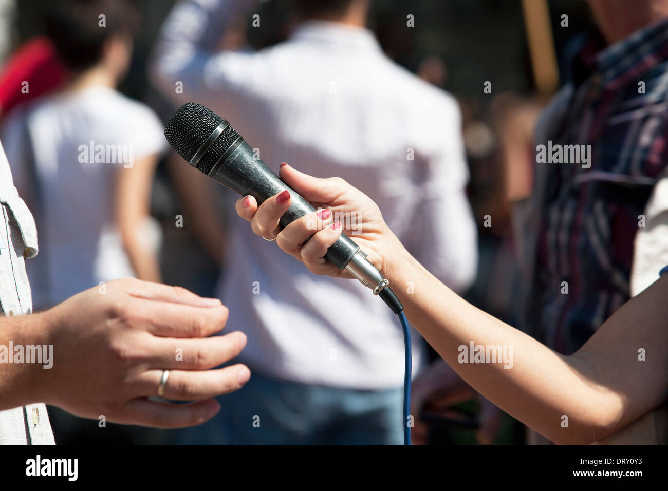 A journalist is making a interview with a microphone Stock Photo - Alamy