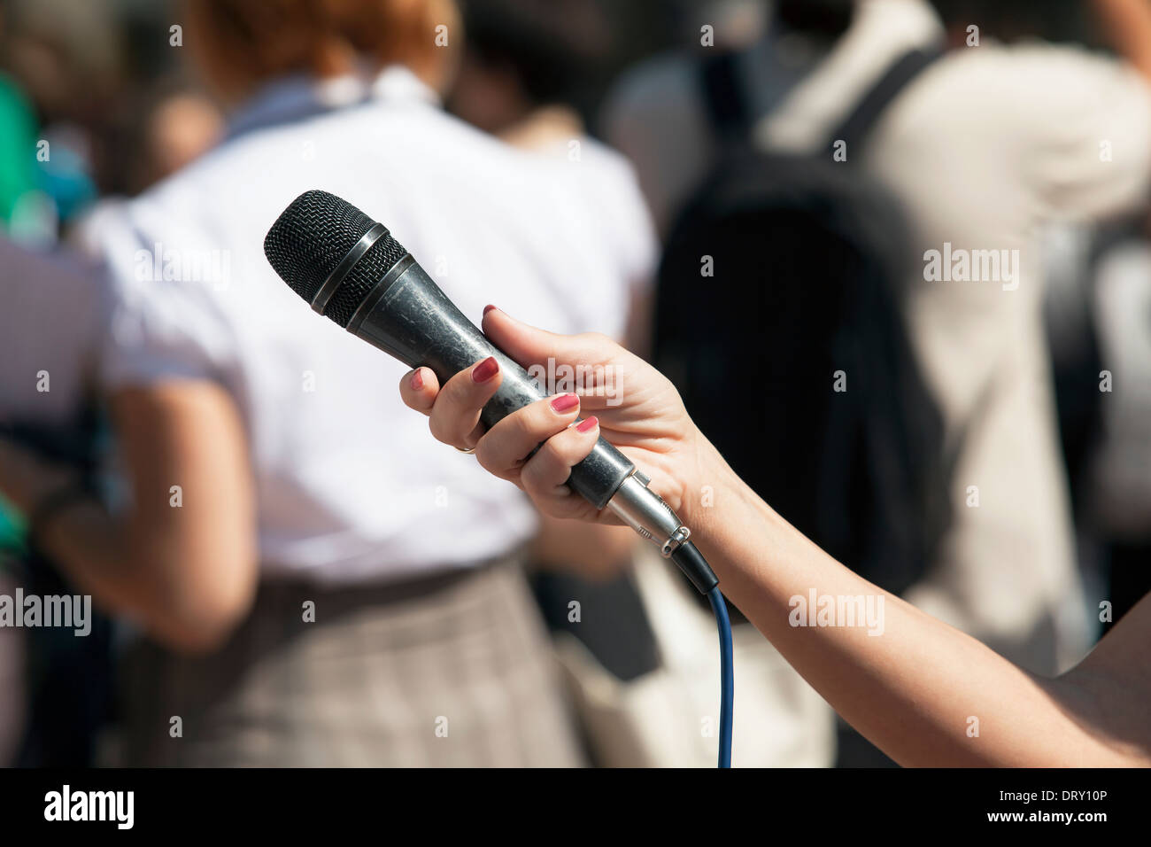 A journalist is making a interview with a microphone Stock Photo - Alamy