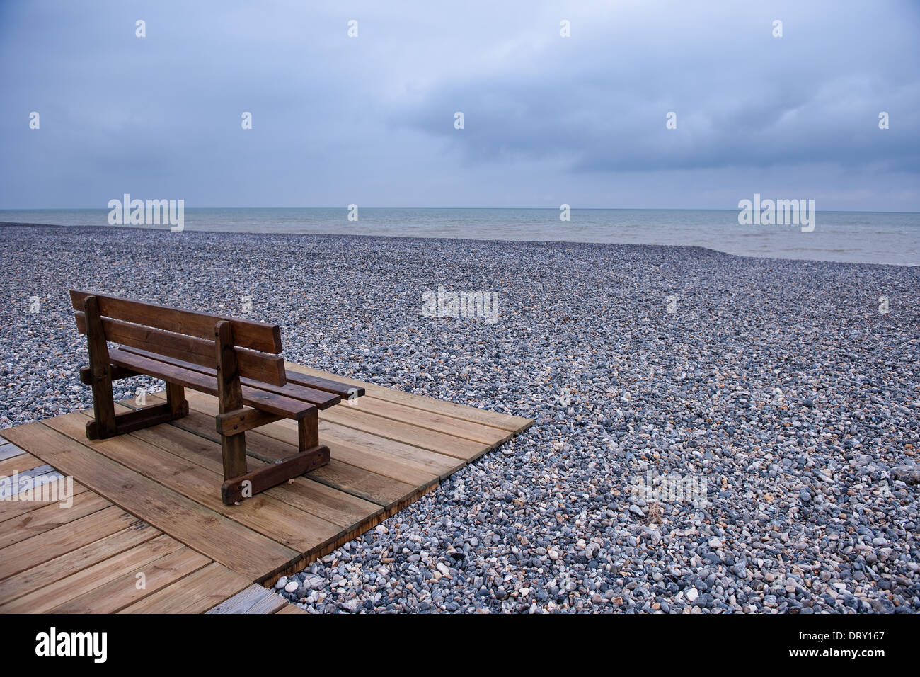 Wooden bench at a pebbles beach Stock Photo - Alamy