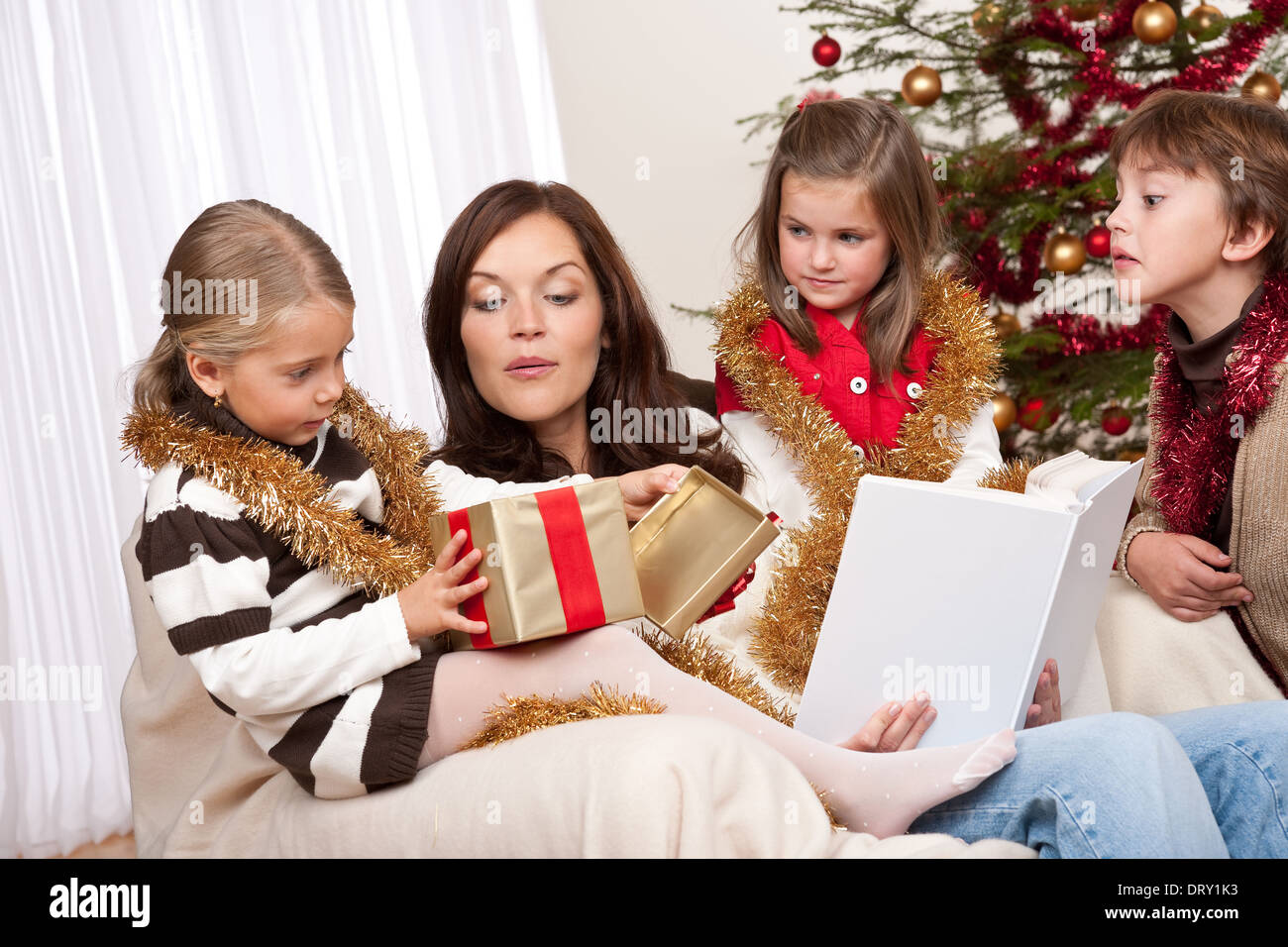 Happy family: mother with three children Stock Photo - Alamy