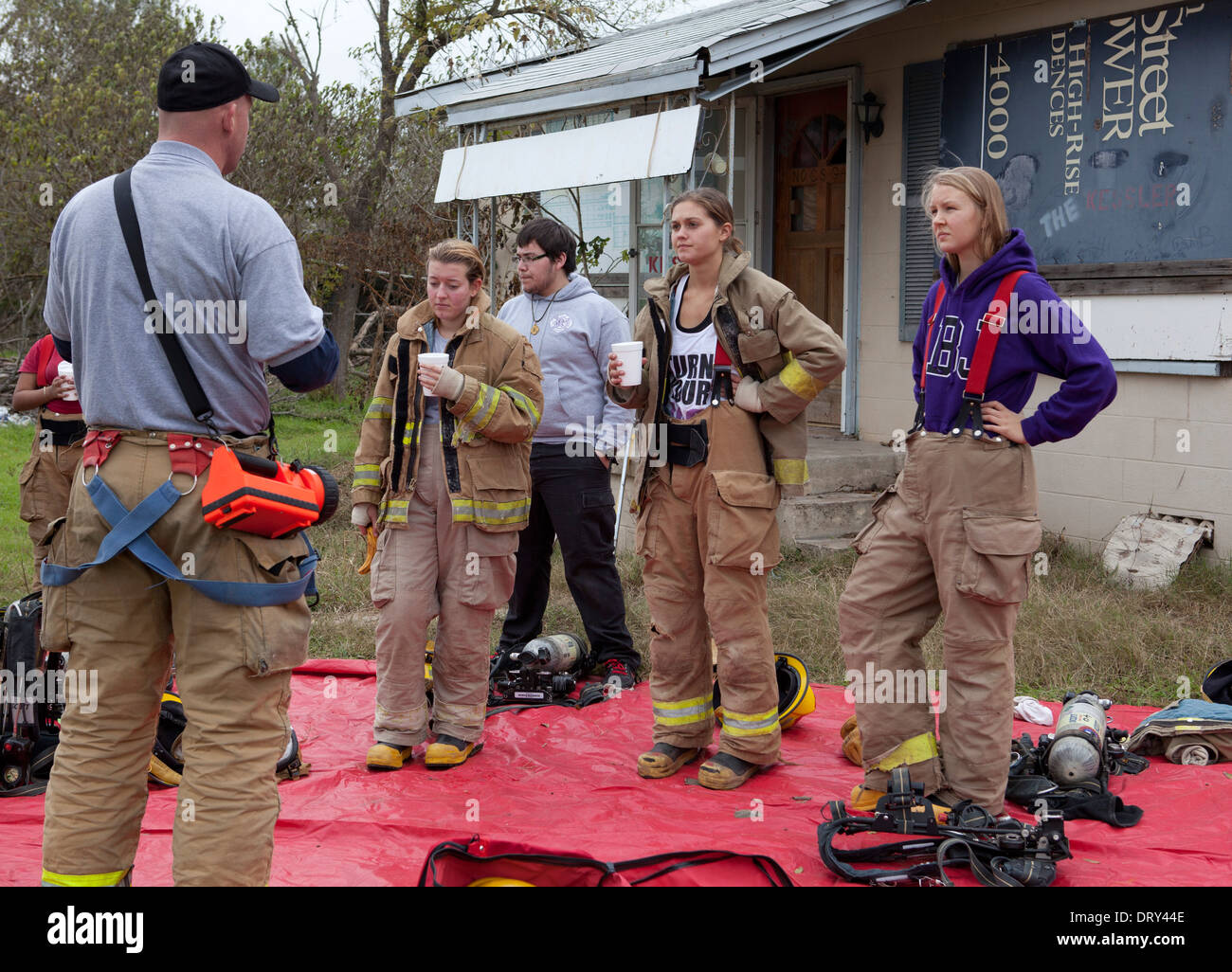 Female students from high school fire training class listen to ...