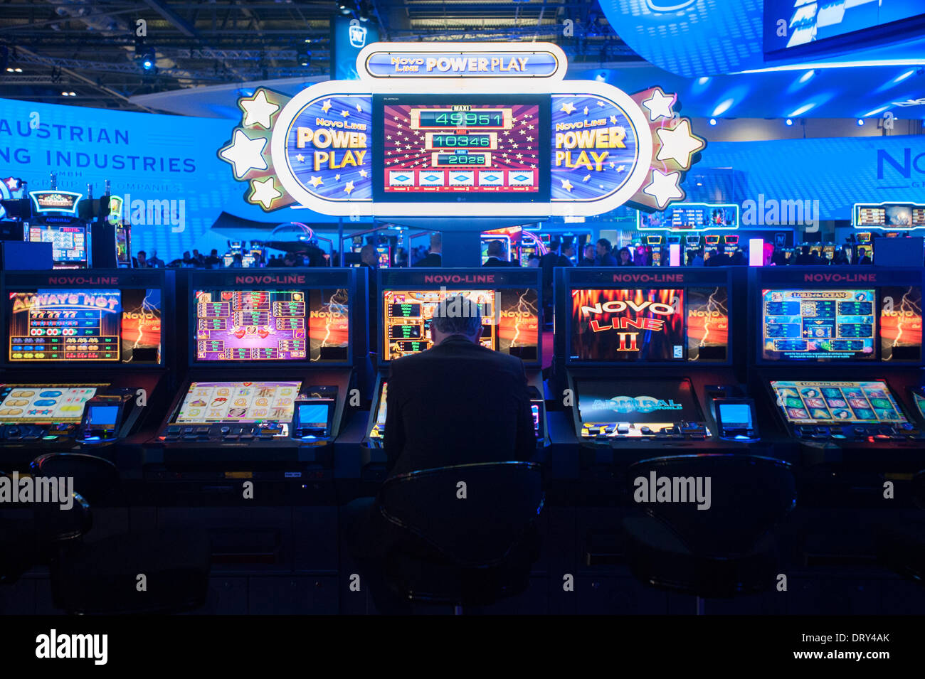 London, UK - 4 February 2014: a man plays at slot machines at the ICE ...