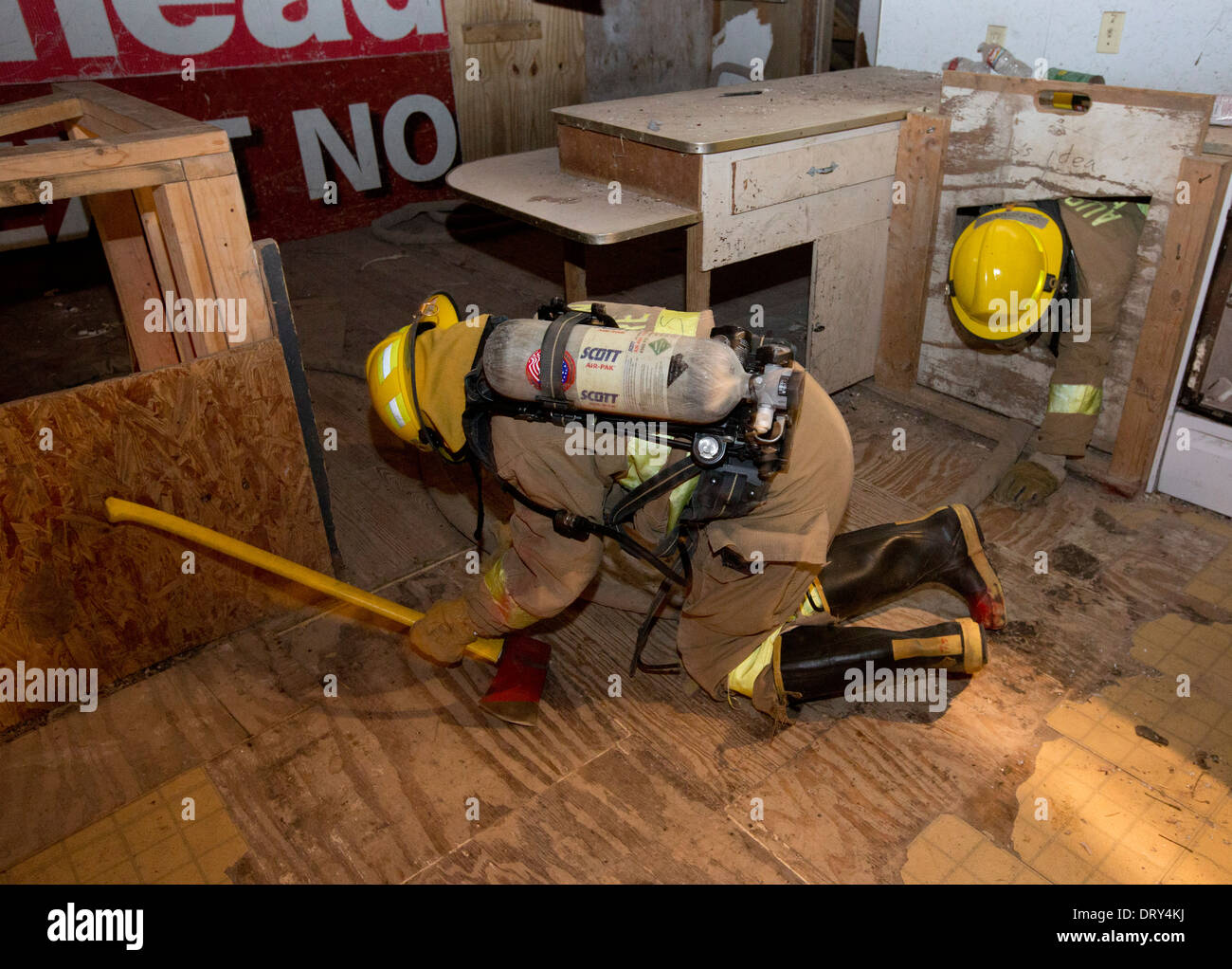 High school fire academy students crawl through obstacle-filled house ...
