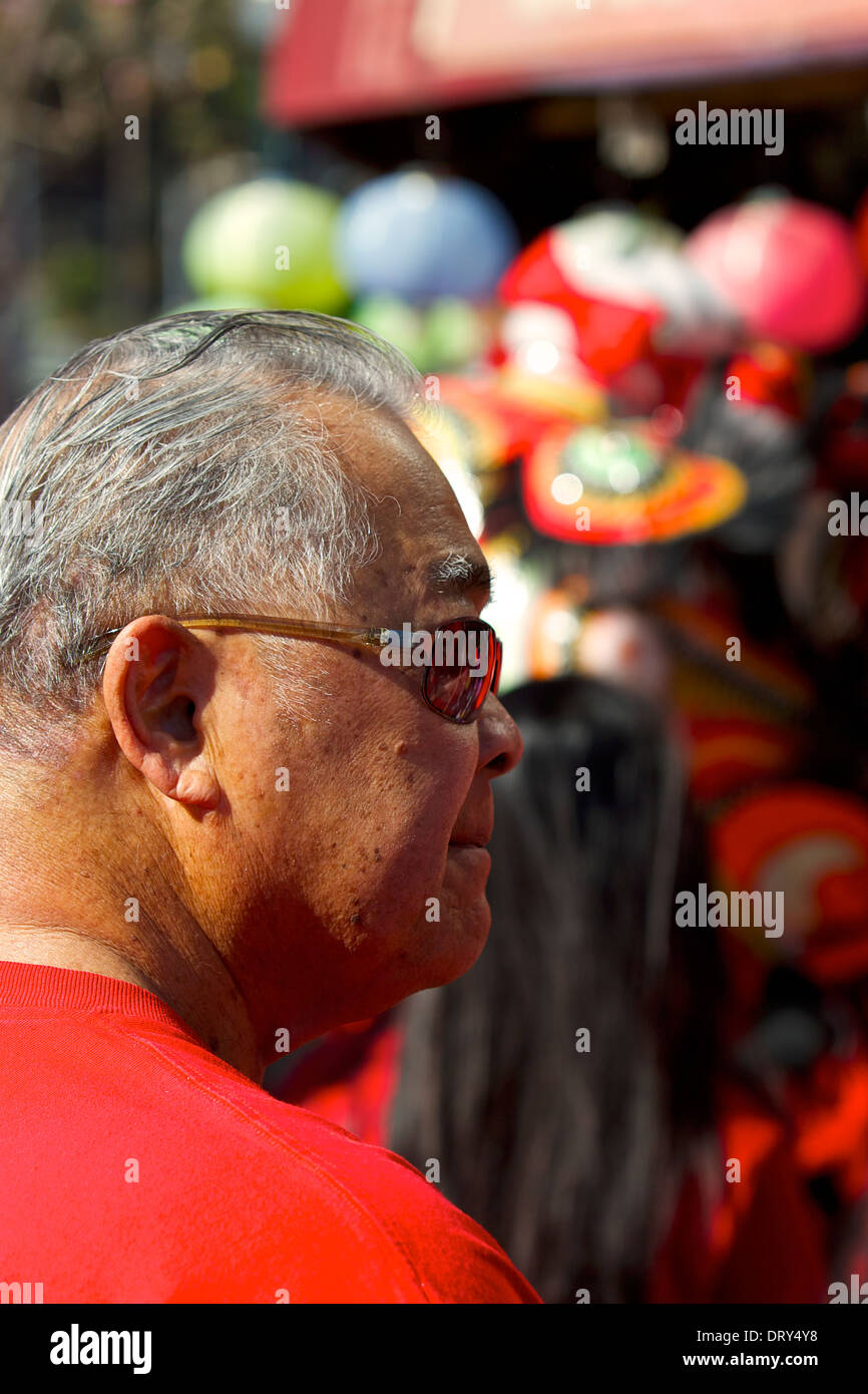 Chinese Man watches the Dragon Dance outside a shop in Chinatown, Los ...