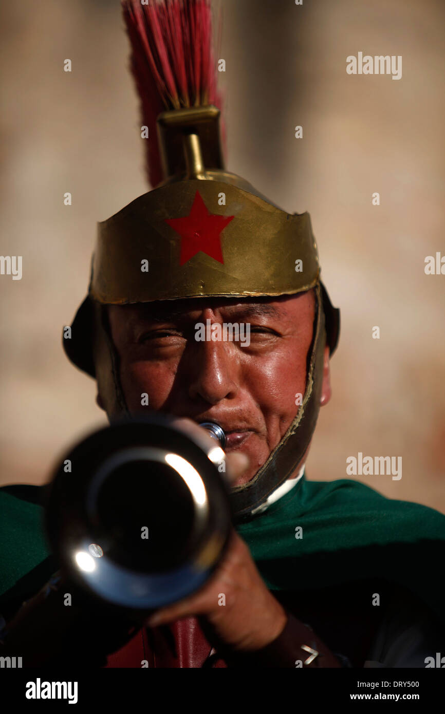 A man dressed as a Roman legionary plays a bugle trumpet during Semana ...