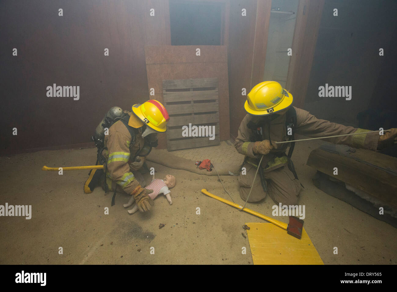 High school fire academy students crawl through smoke-filled house ...