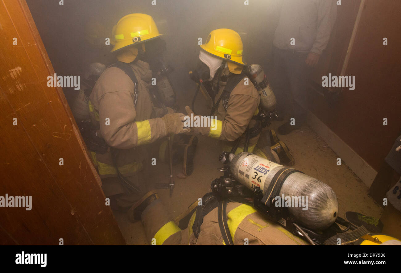 High school fire academy students crawl through smoke-filled house ...