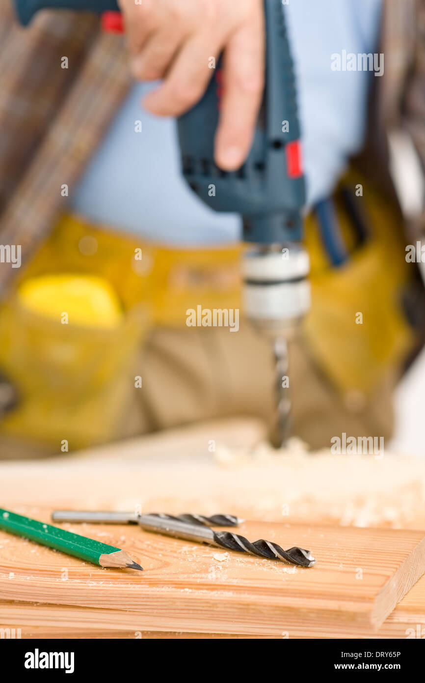 Home improvement - handyman drilling wood Stock Photo - Alamy