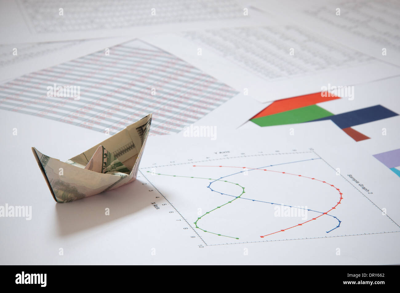 Dollar banknote paper boat over financial data Stock Photo - Alamy