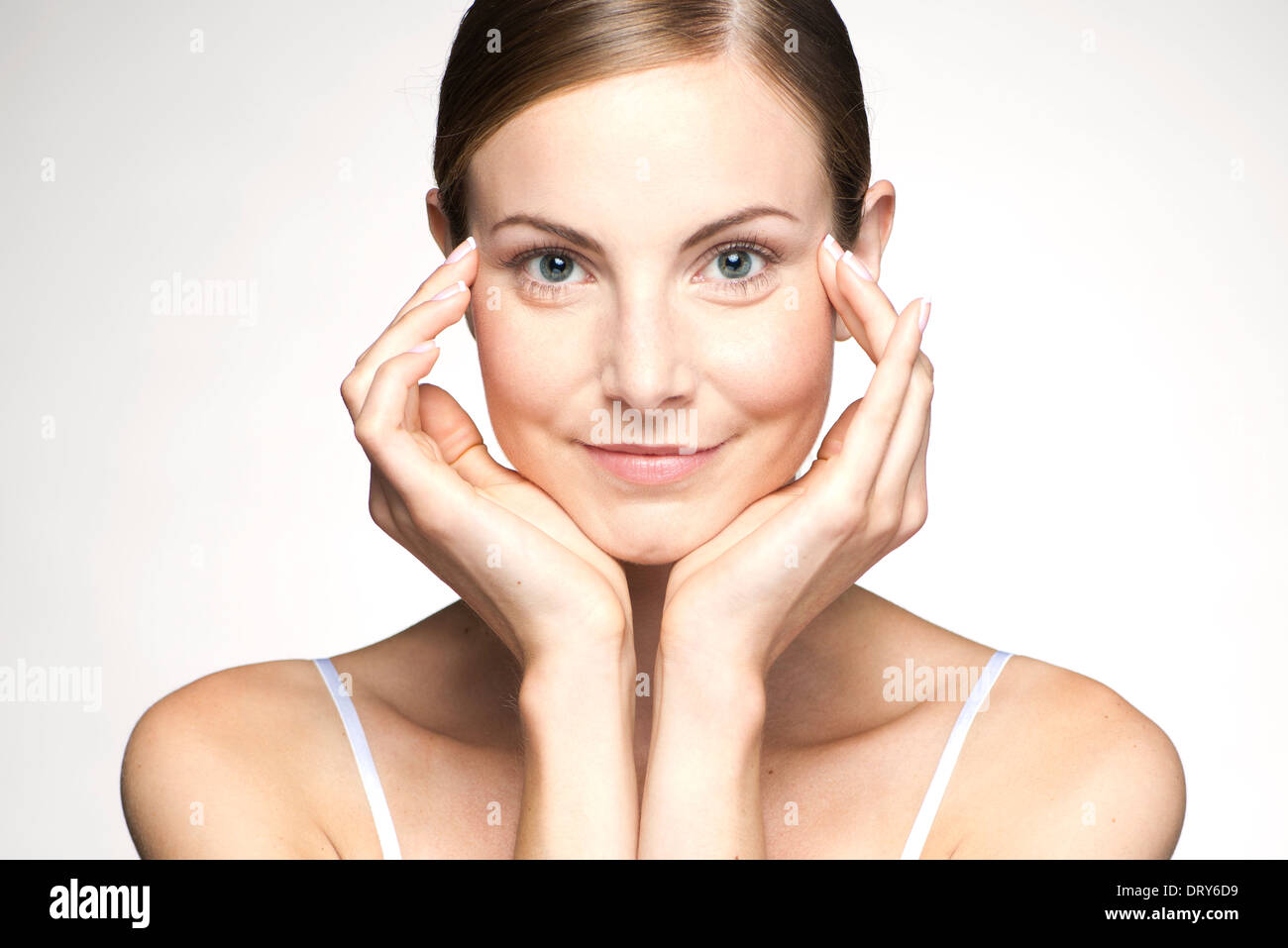 Young woman rubbing temples Stock Photo - Alamy