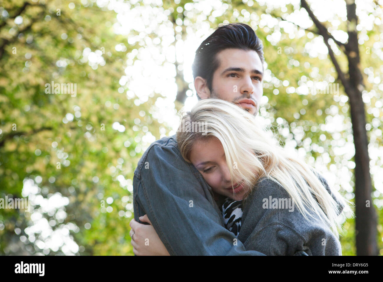 Couple embracing outdoors Stock Photo - Alamy