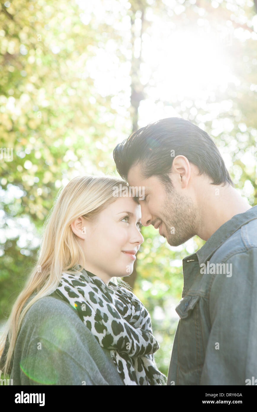 Couple nuzzling each other outdoors Stock Photo - Alamy