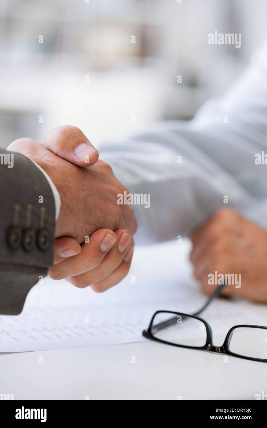 Business deal closed with handshake Stock Photo - Alamy