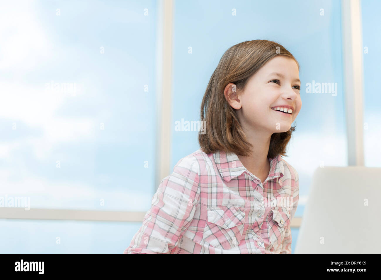 Girl using laptop computer, smiling Stock Photo - Alamy