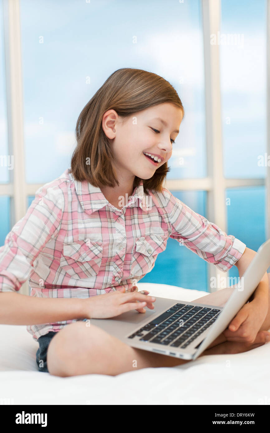 Girl using laptop computer, smiling Stock Photo - Alamy