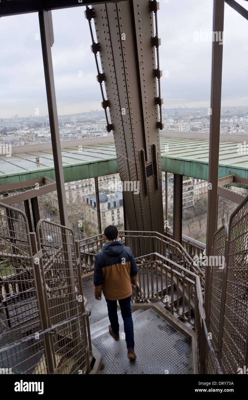 Man descending stairs of steel construction of the Eiffel tower. Paris ...