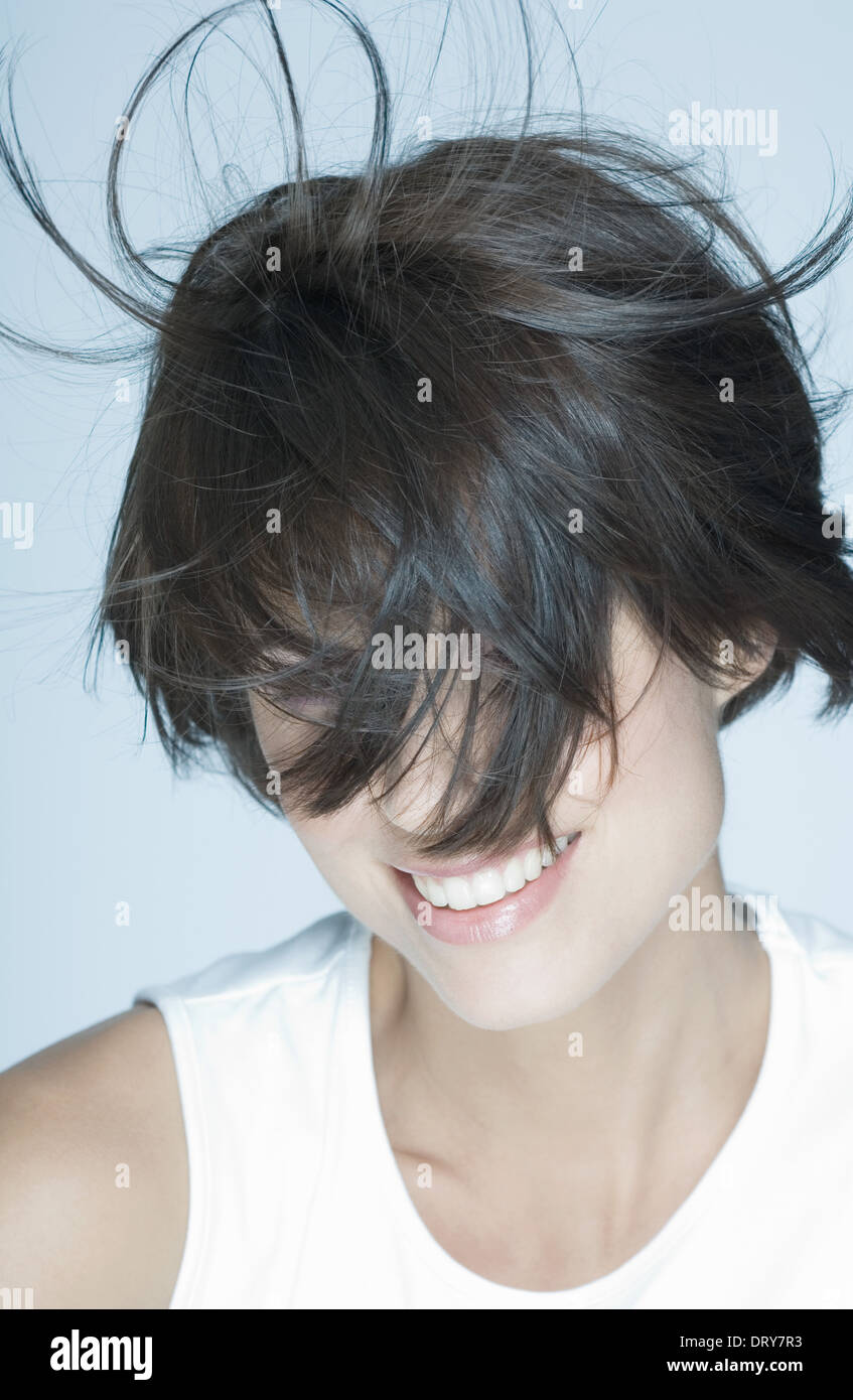 Woman with hair in front of face, smiling, portrait Stock Photo - Alamy