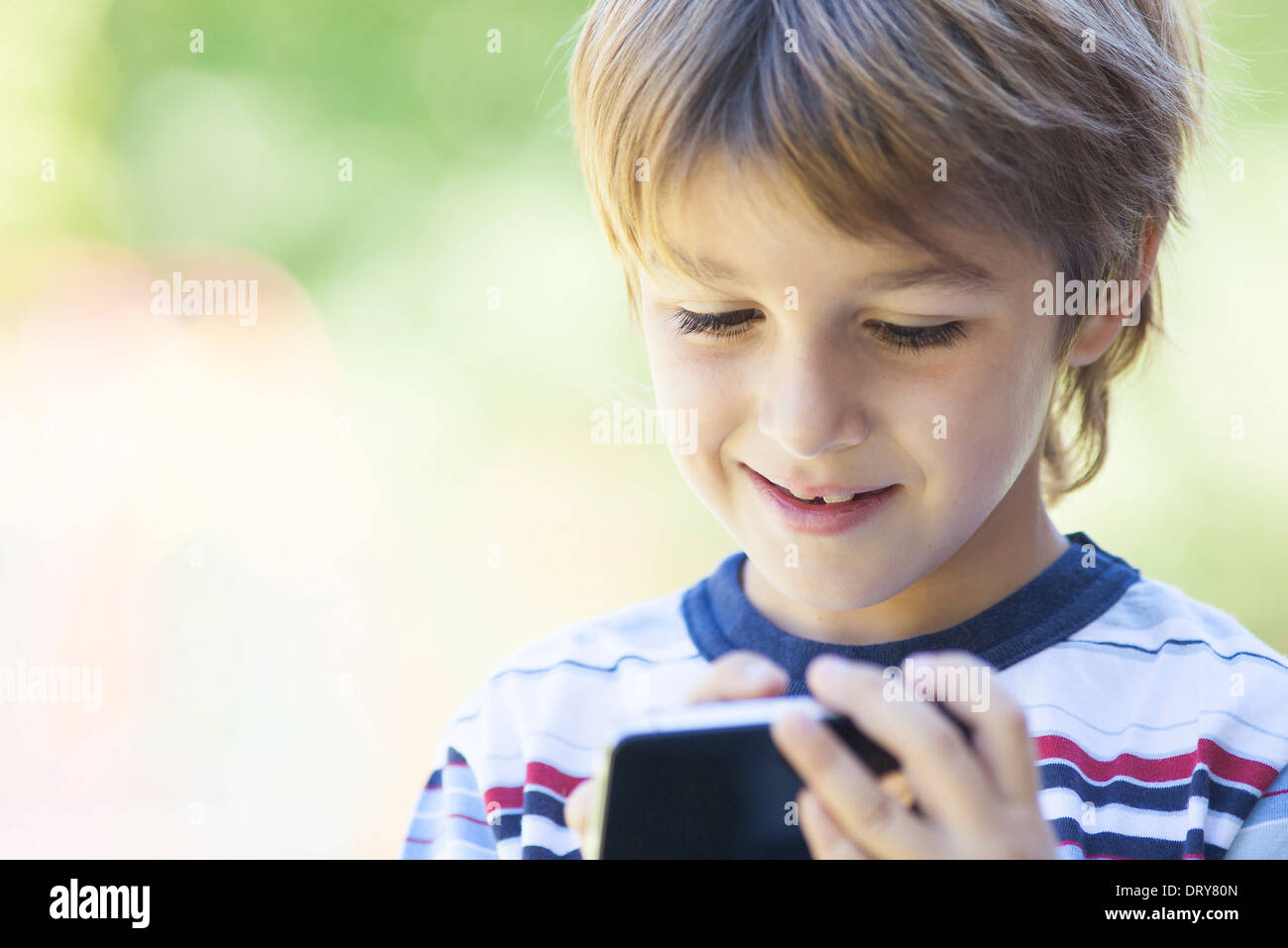 Boy using smartphone Stock Photo - Alamy