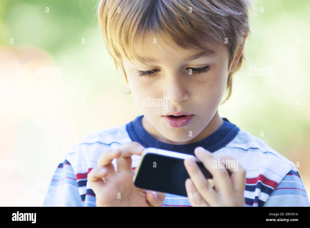 Boy using smartphone Stock Photo - Alamy