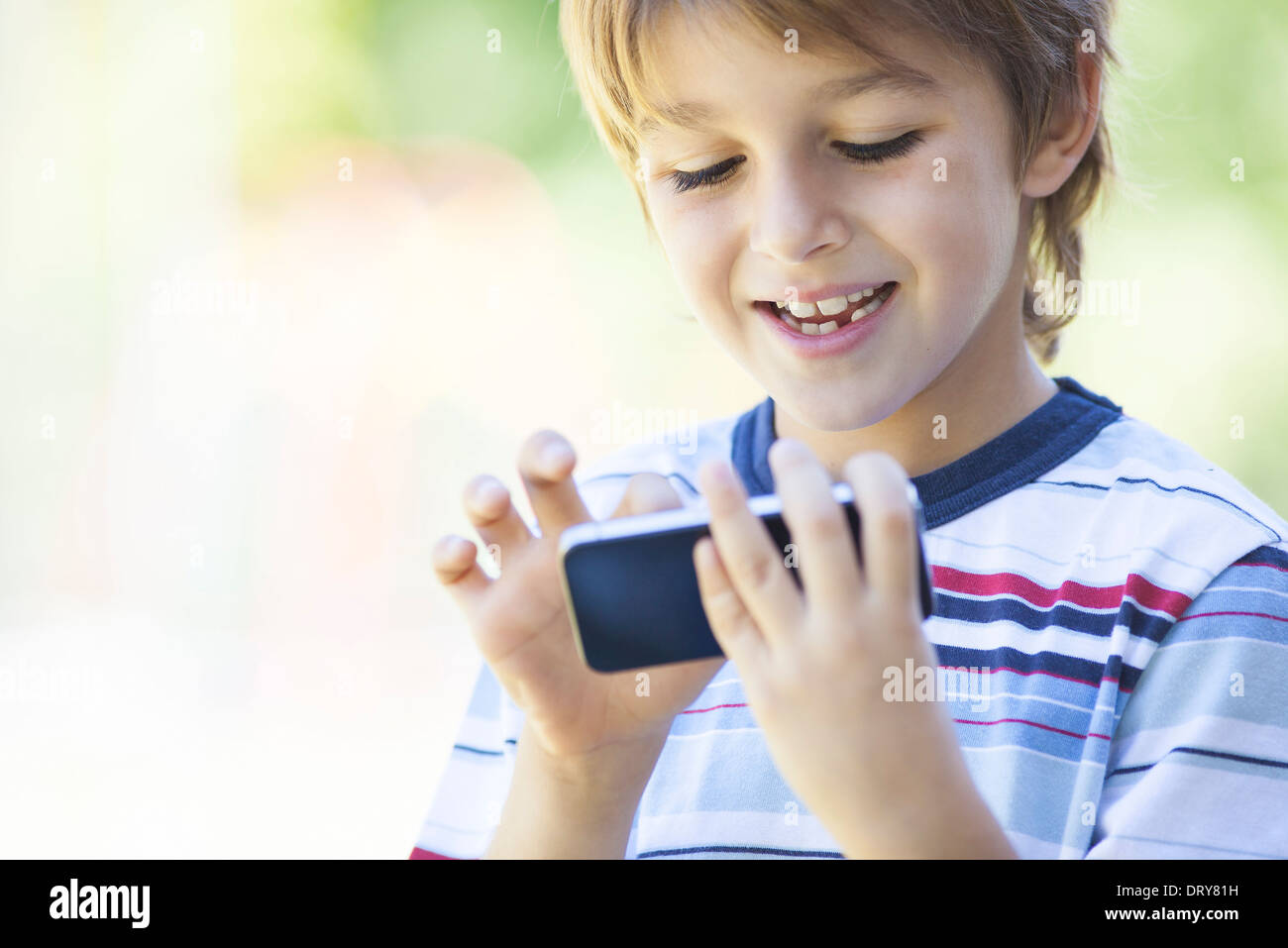 Boy using smartphone Stock Photo - Alamy