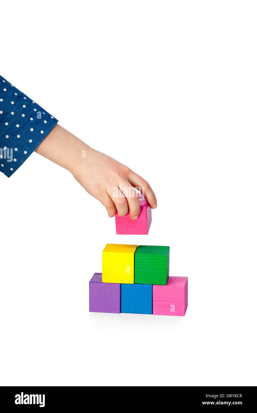 Child's hand building a brick tower isolated on white background Stock ...