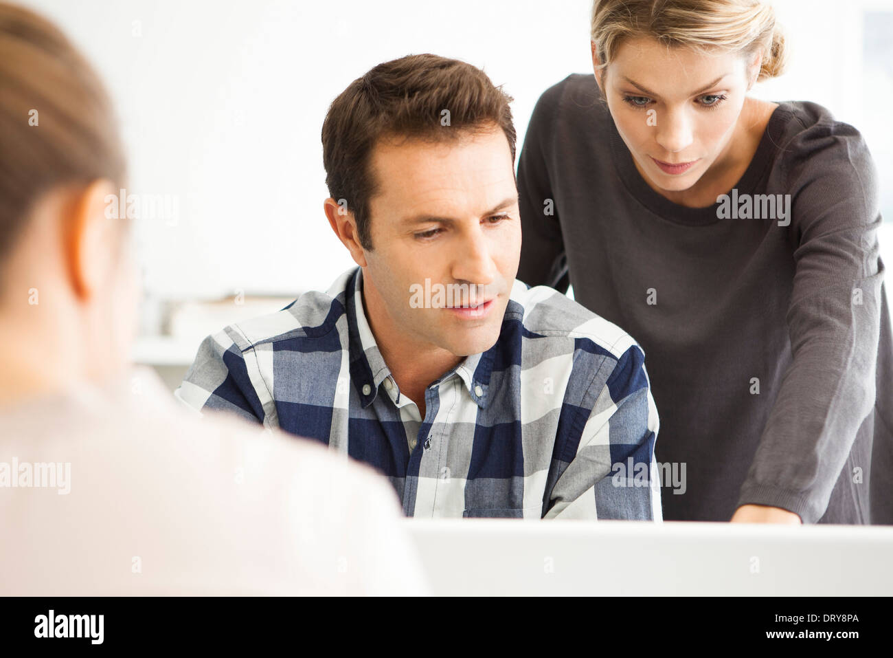 Colleagues working as team on work project Stock Photo - Alamy