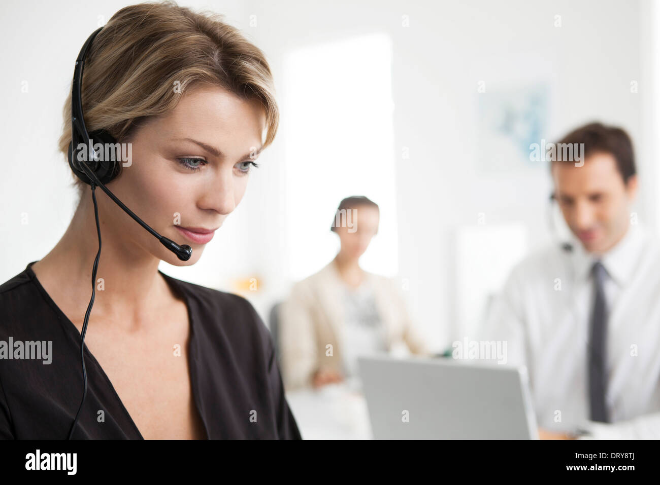 Woman wearing headset focused in hi-res stock photography and images ...
