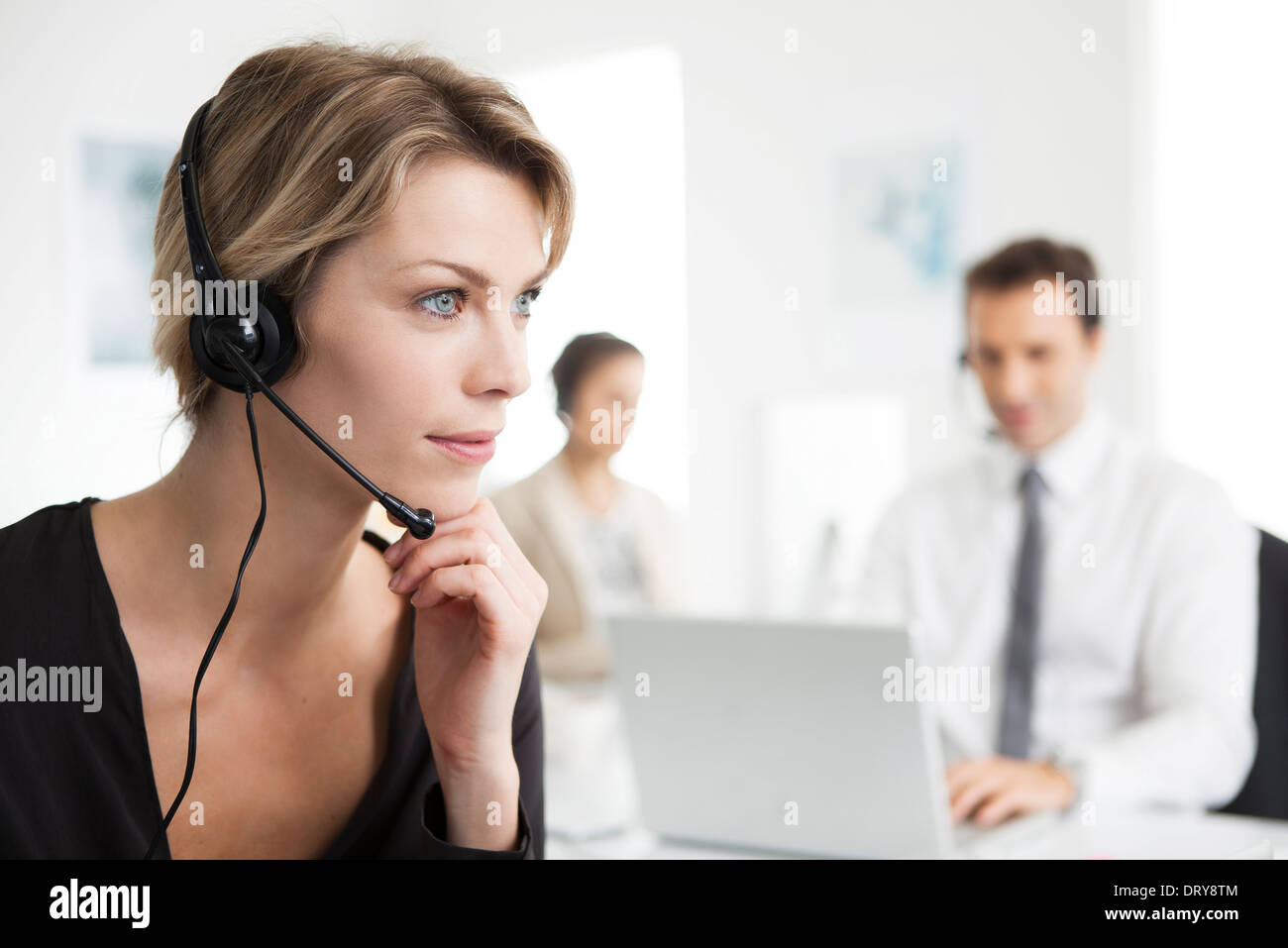 Businesswoman wearing headset working in office Stock Photo - Alamy