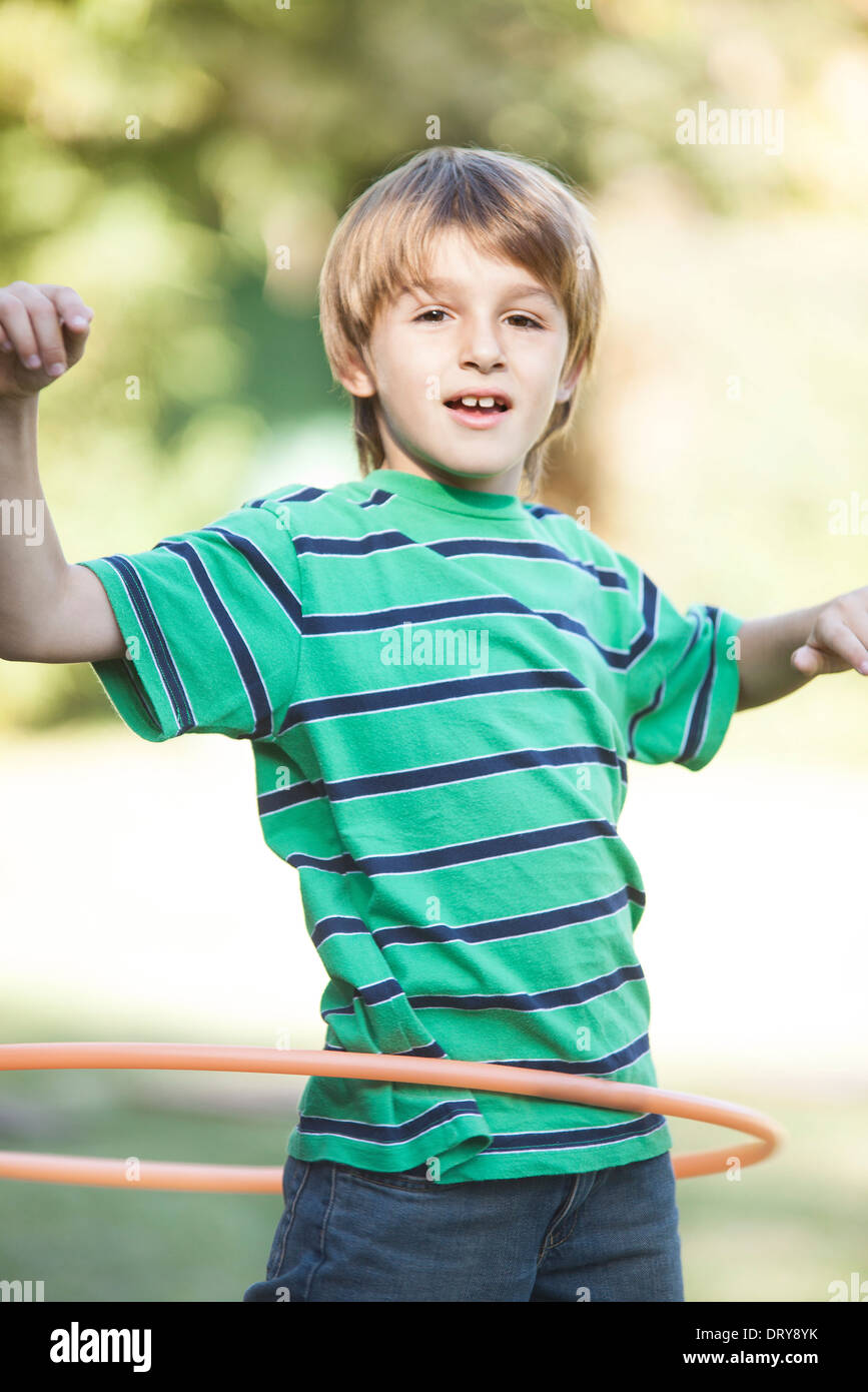 Boy playing with hula hoop Stock Photo - Alamy