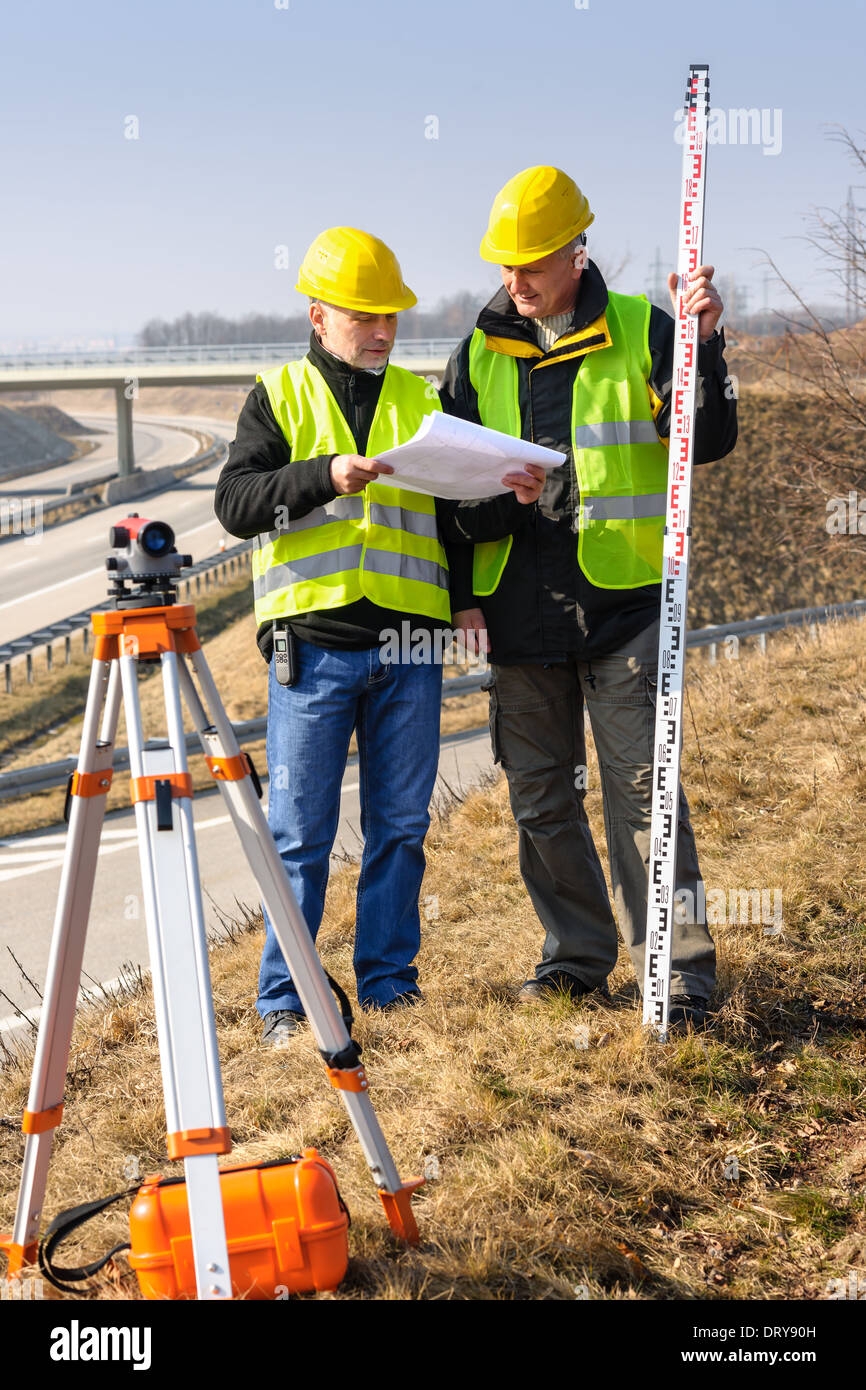 Geodesist read plans on construction site Stock Photo - Alamy