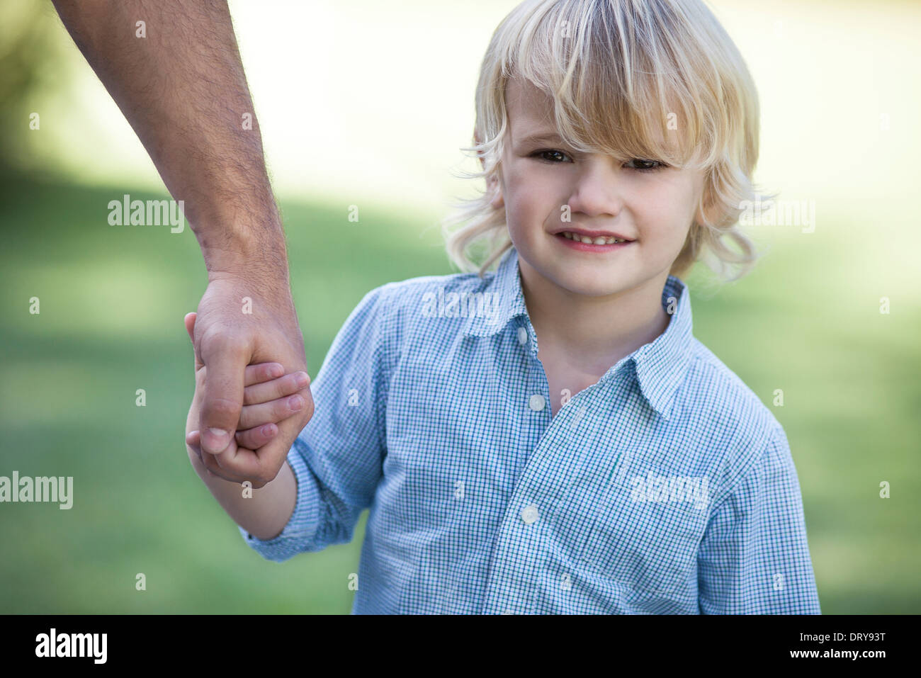 Boy holding father's hand Stock Photo - Alamy