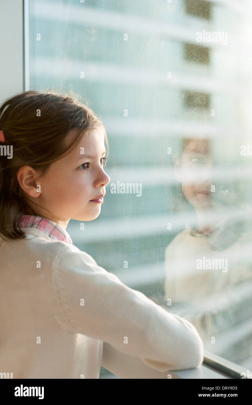 Girl looking out window, portrait Stock Photo - Alamy