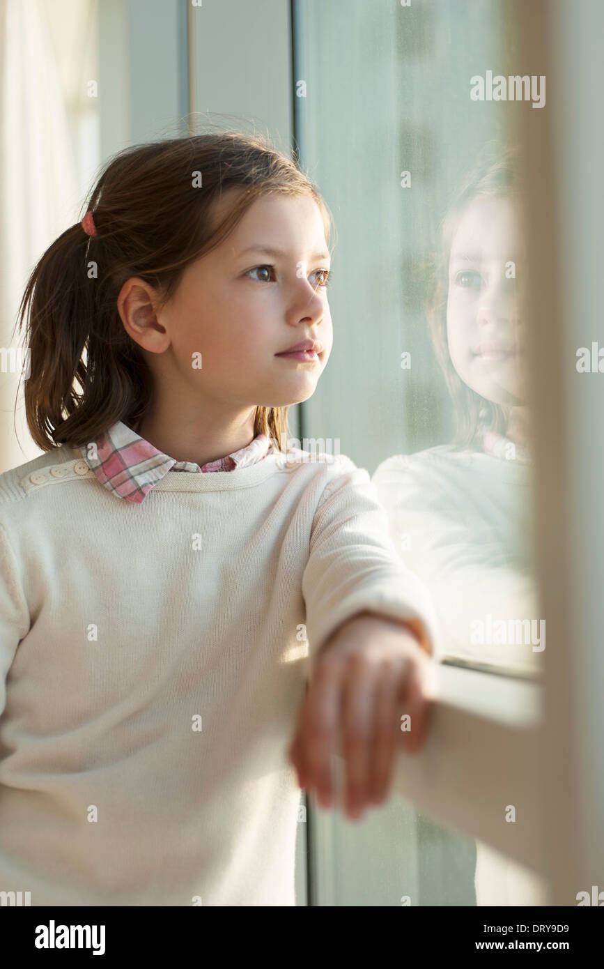 Girl looking out window Stock Photo - Alamy