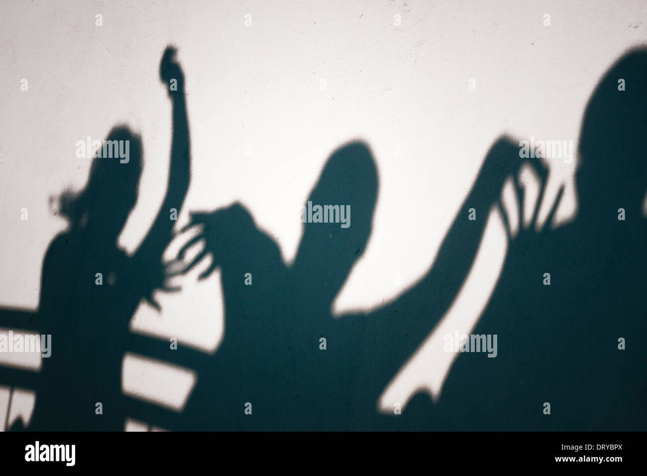 Creative photo of people shadows on white wall Stock Photo - Alamy
