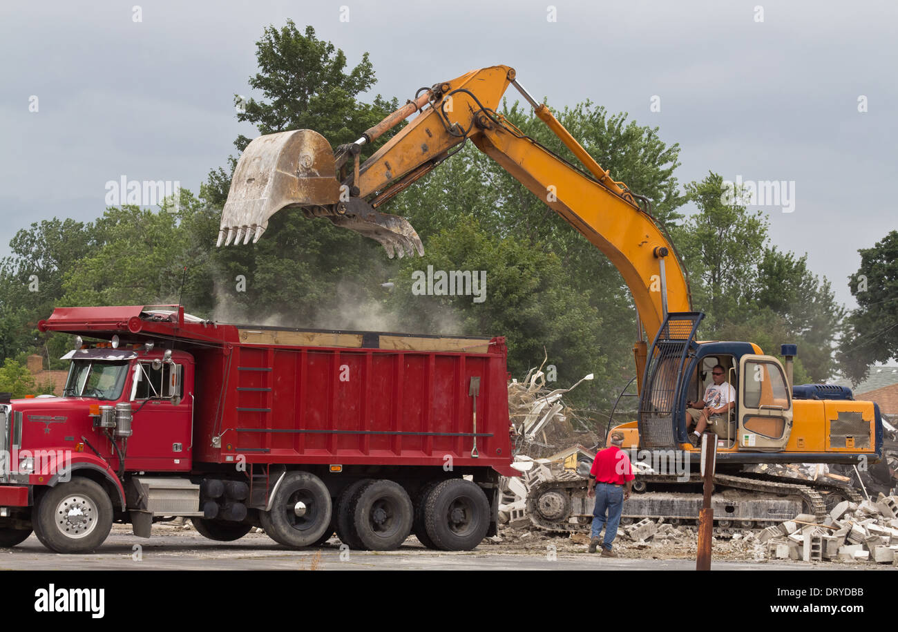 Digger backhoe with operator demolishing building in the city Excavator ...