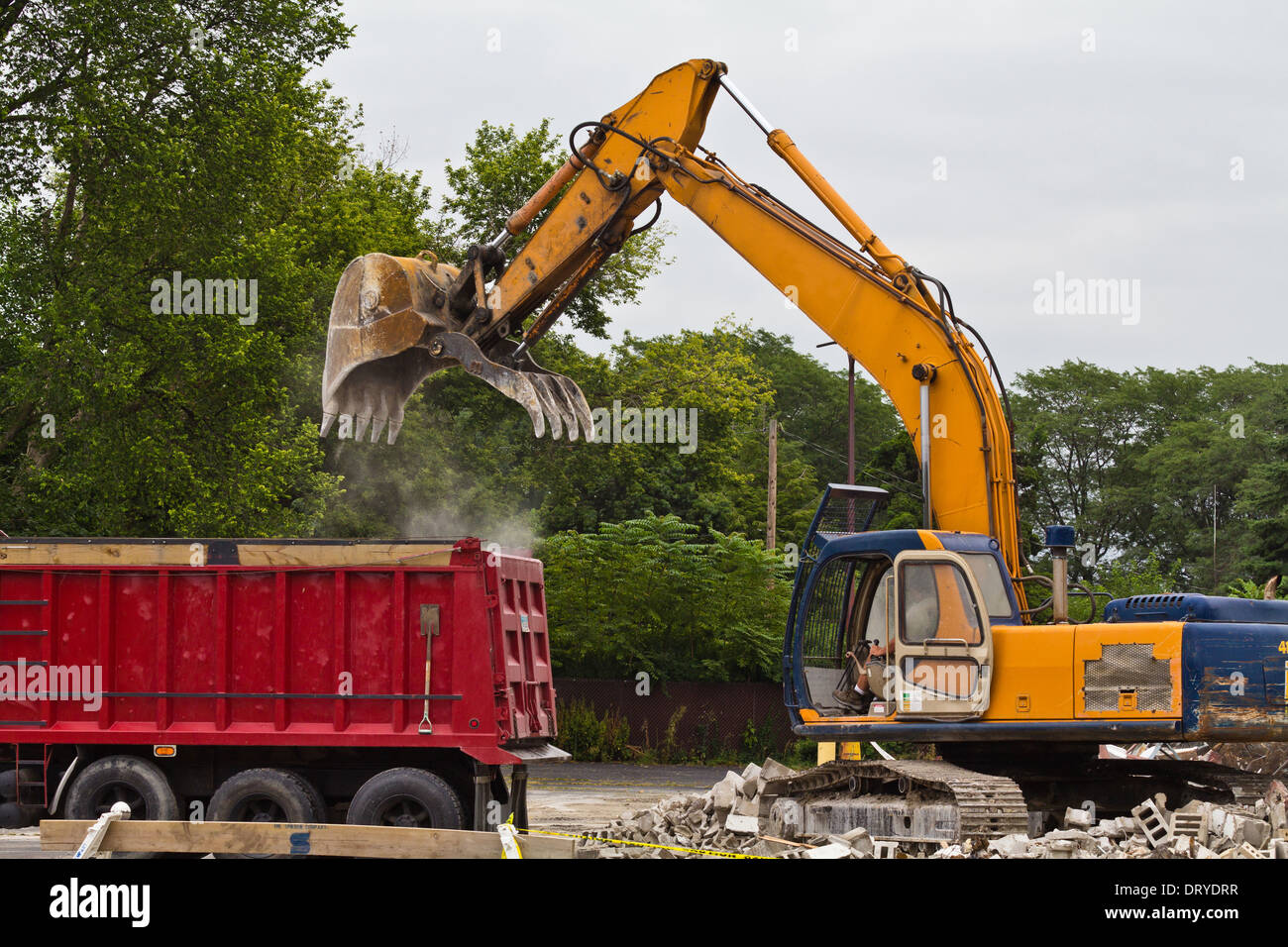 Excavator driver working on construction site digger demolishing ...