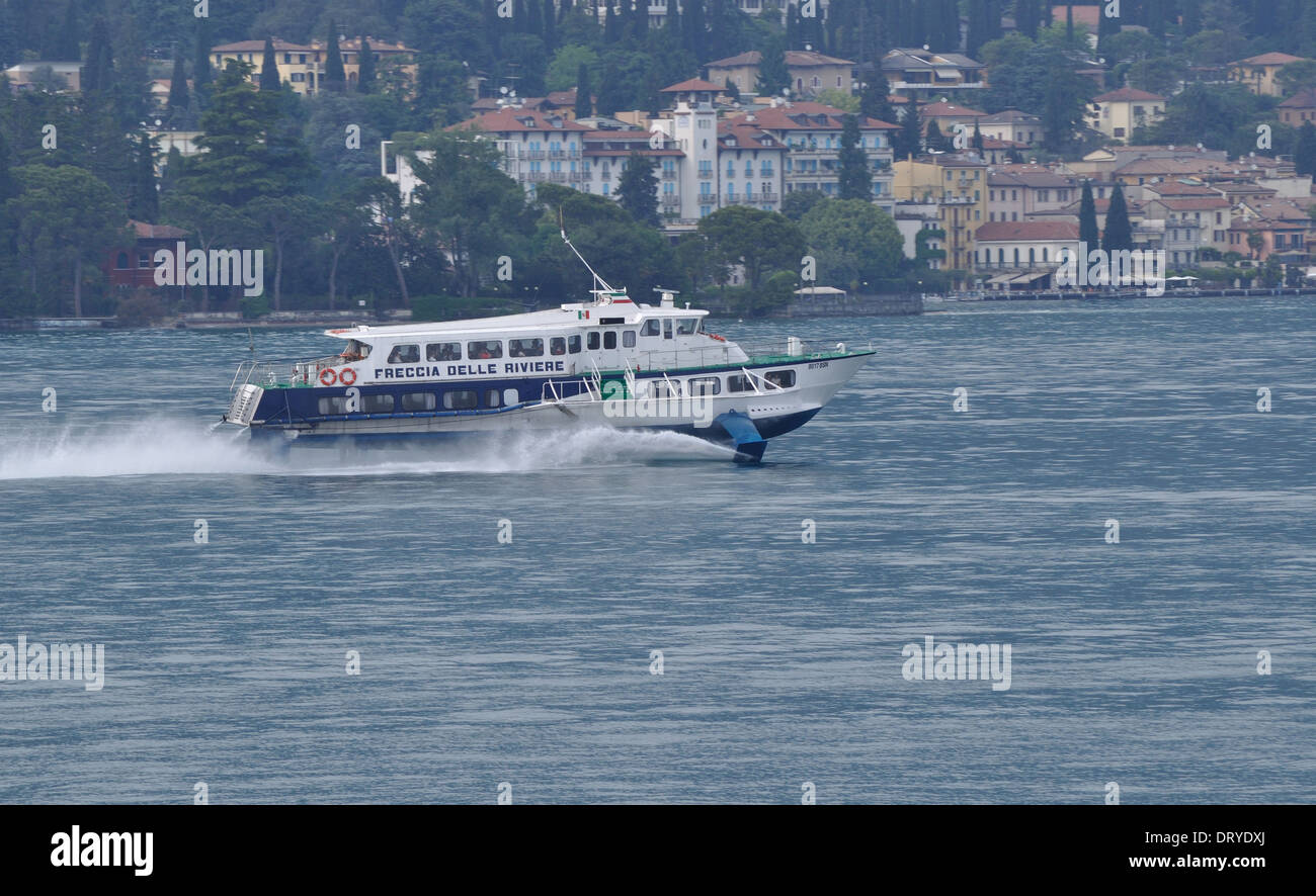 One of the fast hydrofoil ferries speeds past Gardone Riviera on Lake ...