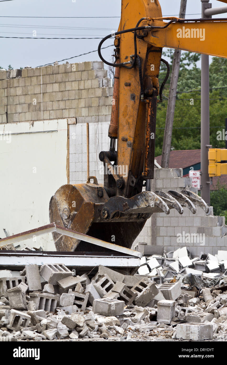 Excavator driver working on construction site digger demolishing ...