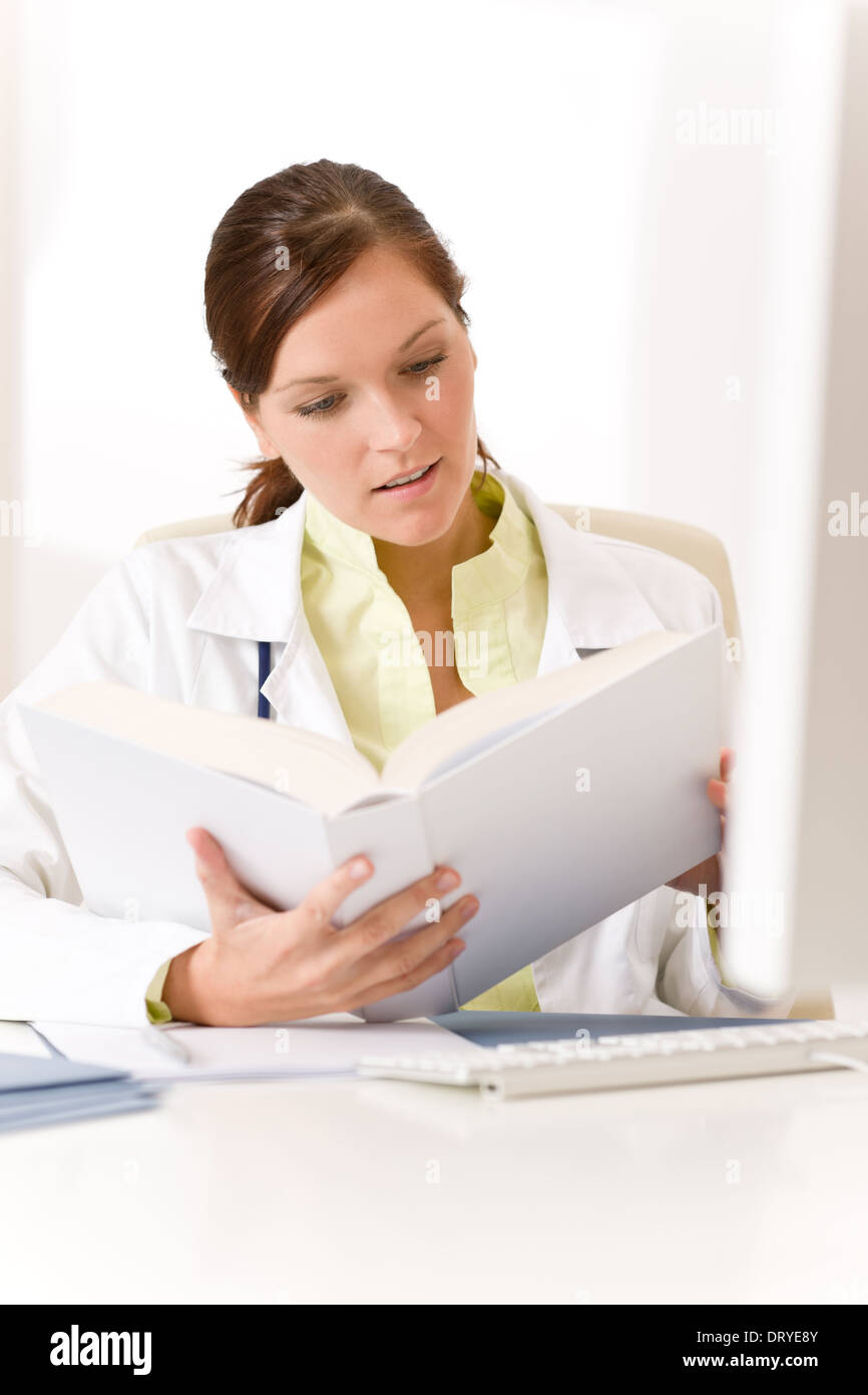 Female doctor read book in clinic Stock Photo - Alamy