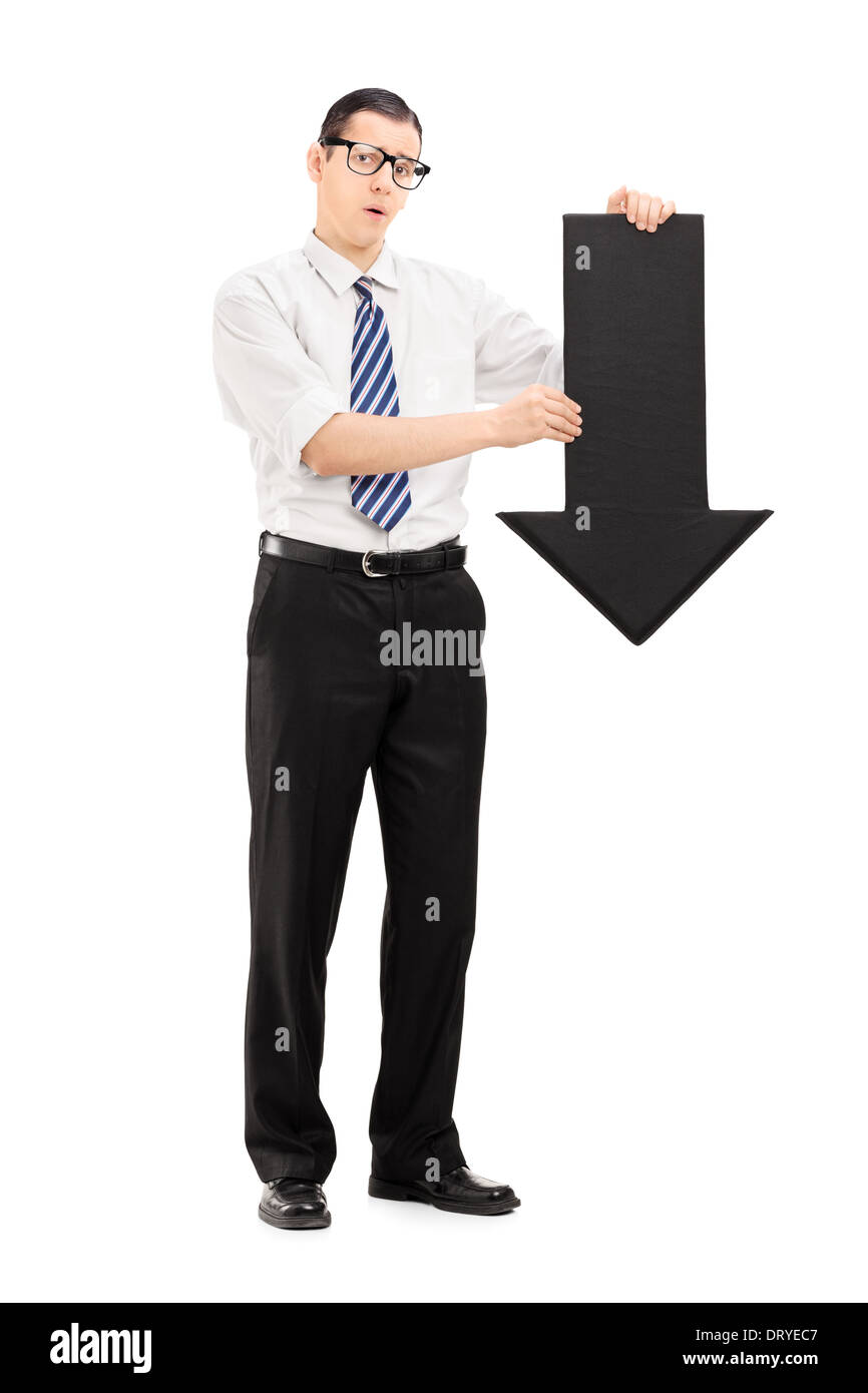 Full length portrait of sad man holding a big black arrow pointing down ...